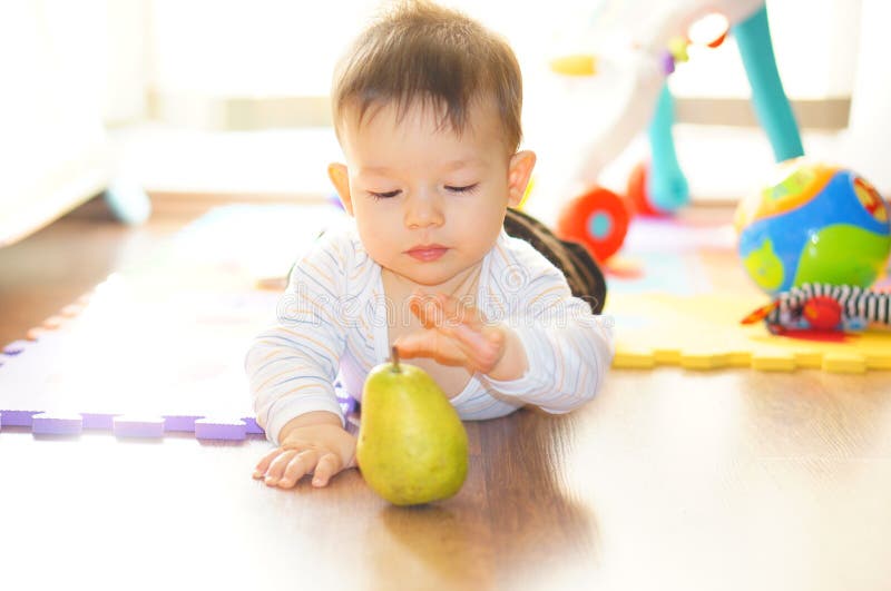 Baby and pear stock photo. Image of lying, play, food - 48787106