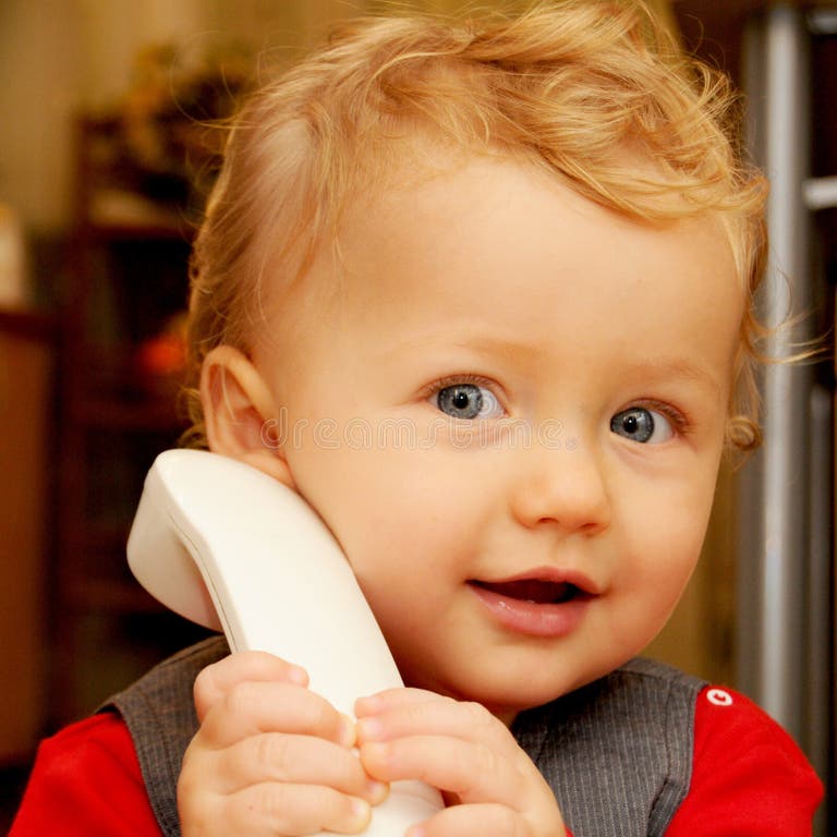 Baby at the phone stock image. Image of childhood, phone - 22960133