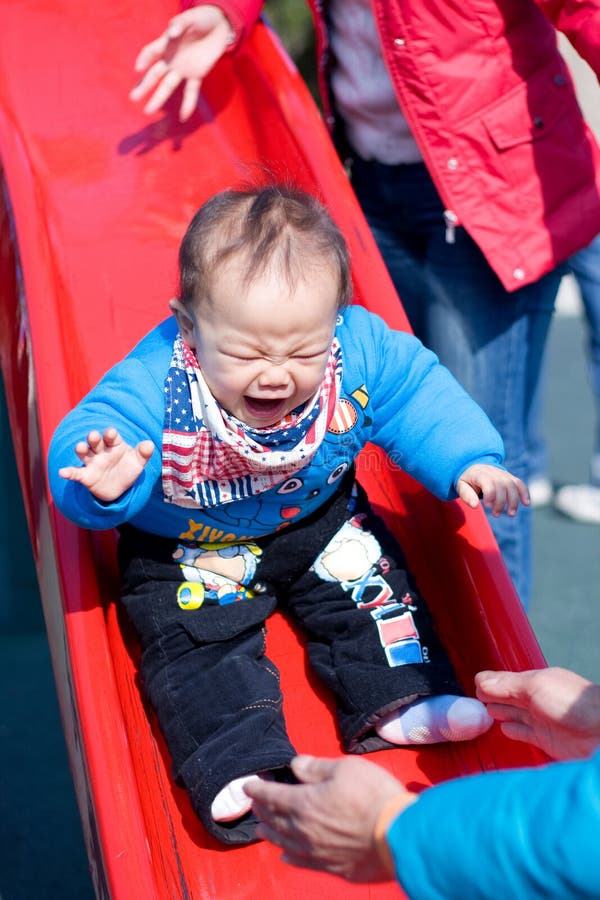 Baby play on slide stock image. Image of encourage, adorable - 14437415