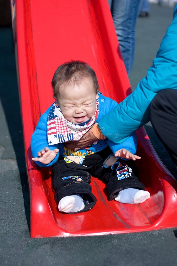 Baby play on slide stock image. Image of bonding, hair - 14437511