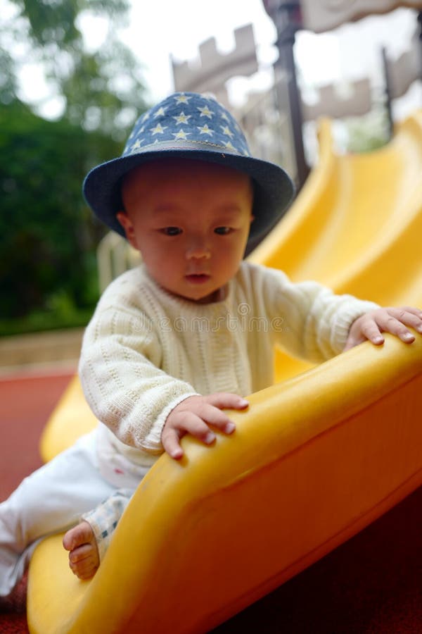 Baby on the Playground Slide Stock Image - Image of moving, active ...