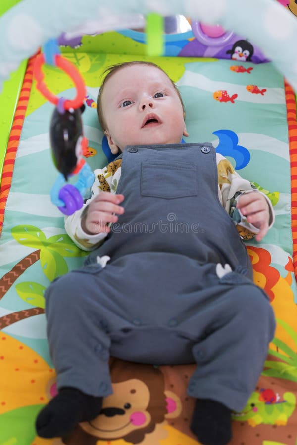 Baby Playing on an Activity Gym Mat Stock Image - Image of eyes, years ...