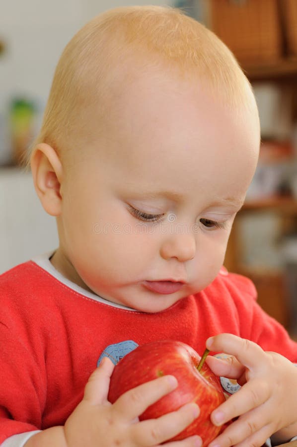 Baby playing with apple stock image. Image of cute, adorable - 26729203