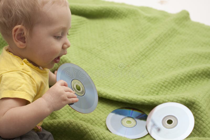 Baby is playing with cd stock image. Image of disk, eating - 13157683