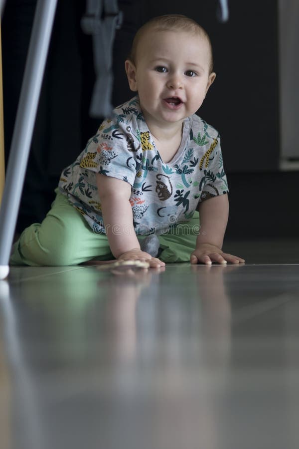Baby Playing on the Floor Under a Chair Stock Photo - Image of chair ...