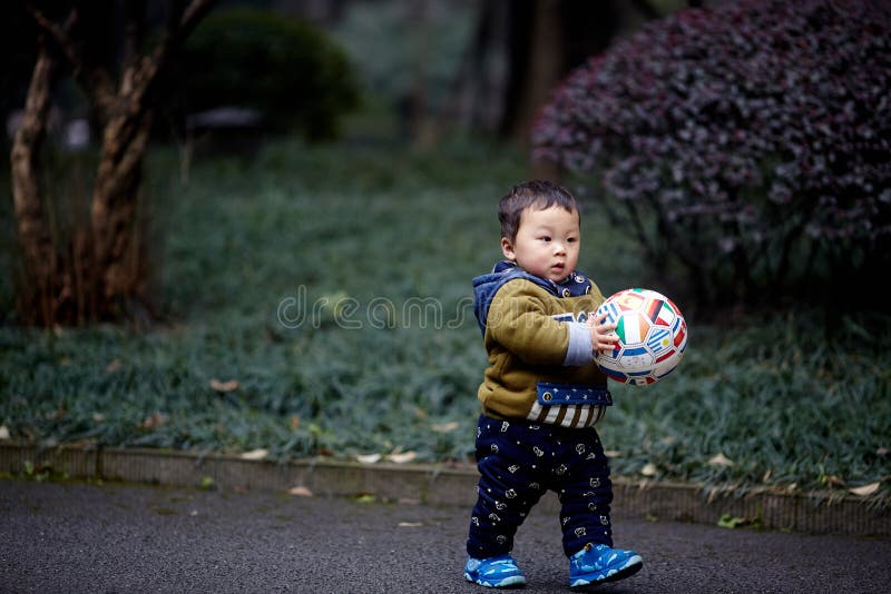 Baby Playing with a Football Stock Photo - Image of tree, recreation ...