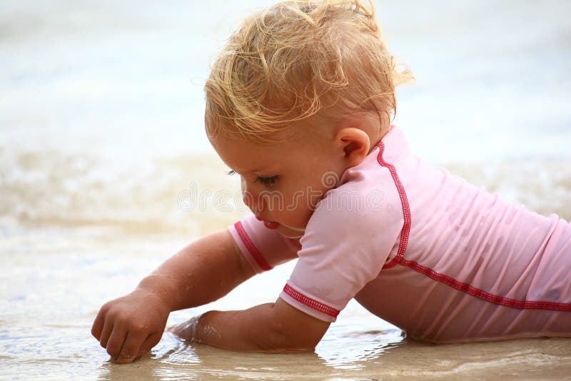 Baby playing in the sand stock image. Image of cute, hawaii - 12586629