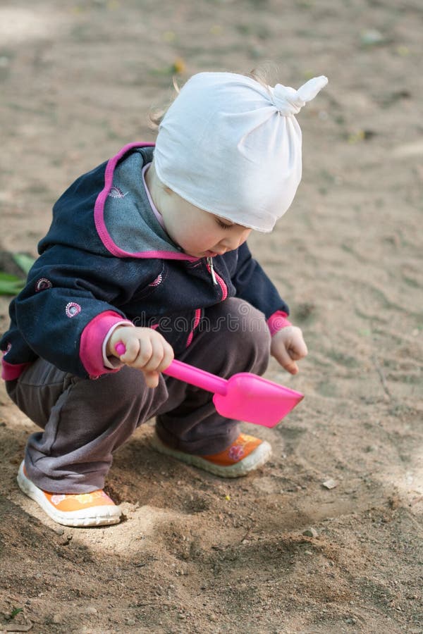Baby playing in a sandpit stock photo. Image of child - 32350376