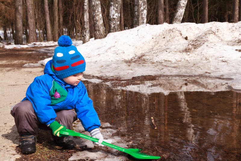 Baby playing in spring mud stock image. Image of dirt - 30420345