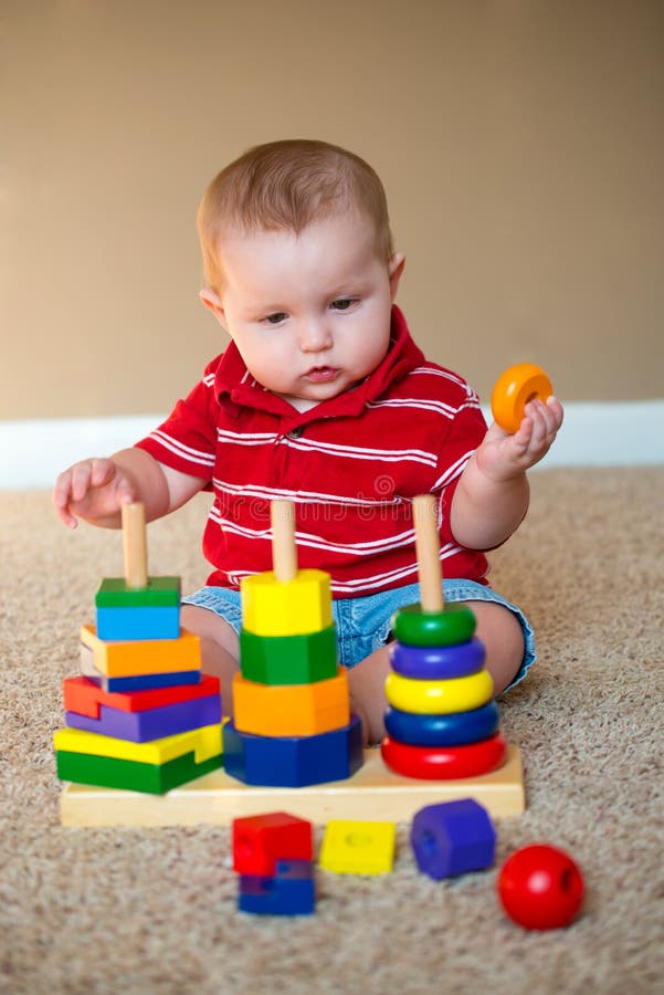 Baby Playing with Stacking Learning Toy Stock Photo - Image of ...