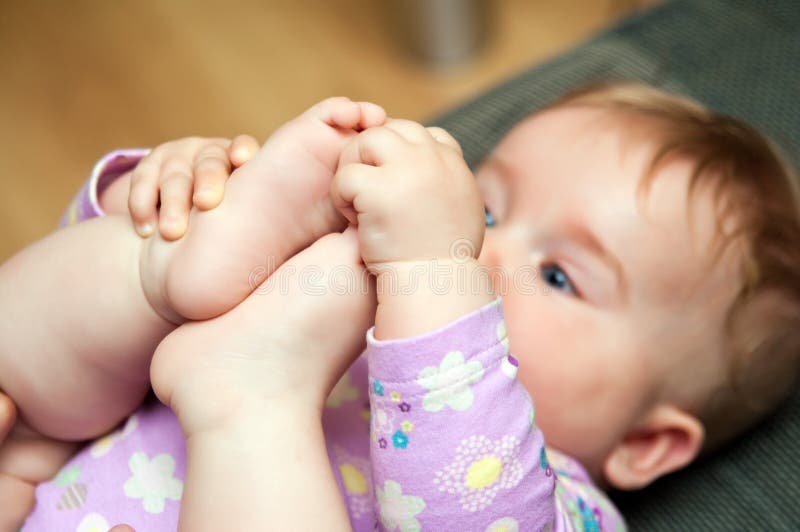Baby playing with toes stock photo. Image of adorable - 16348990