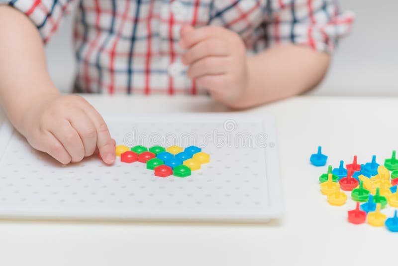 The Baby Plays with a Mosaic Sitting at a Table Stock Image - Image of ...