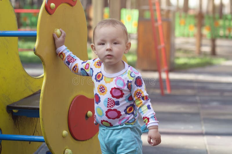 The Baby Plays on the Playground in the Park Stock Photo - Image of ...