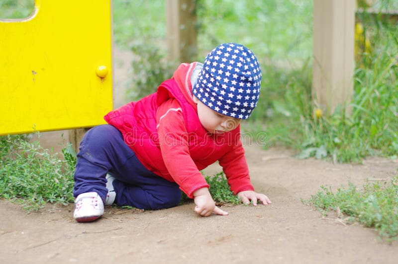 Baby Points Something Sitting on the Ground Stock Image - Image of ...