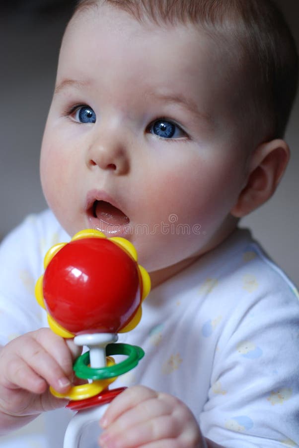 Baby with rattle stock photo. Image of cute, child, looking - 6213500