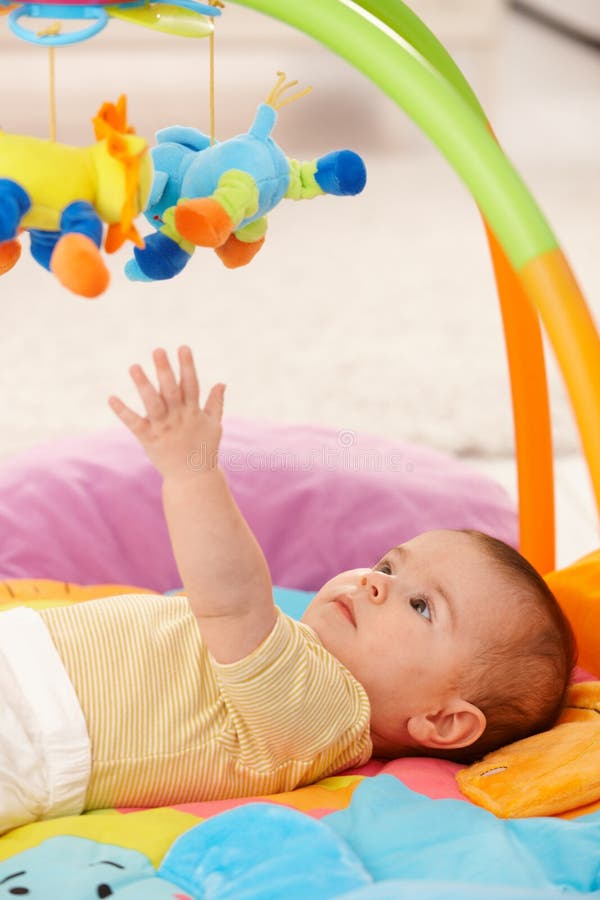 Baby reaching for toy stock photo. Image of caucasian - 18075922