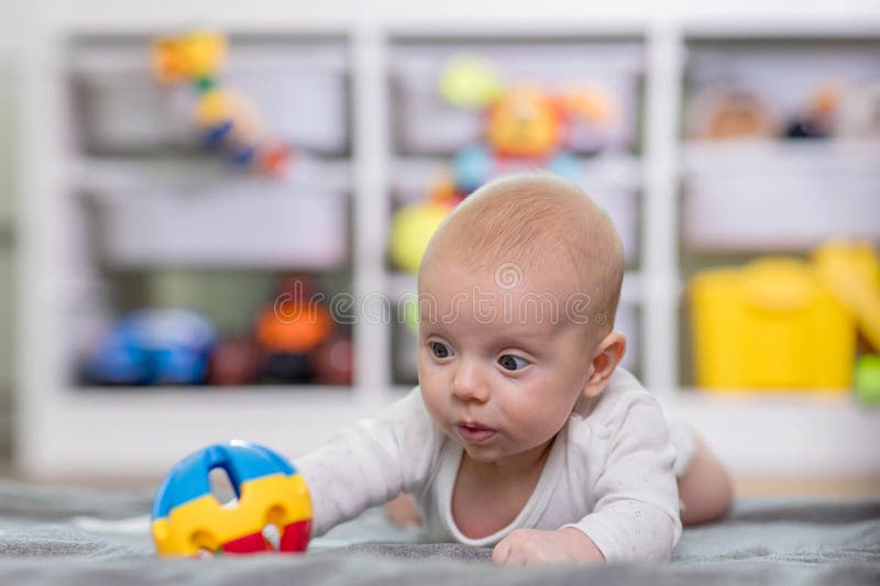 Baby Reaching for Toy. Baby Development Stock Photo - Image of lovely ...