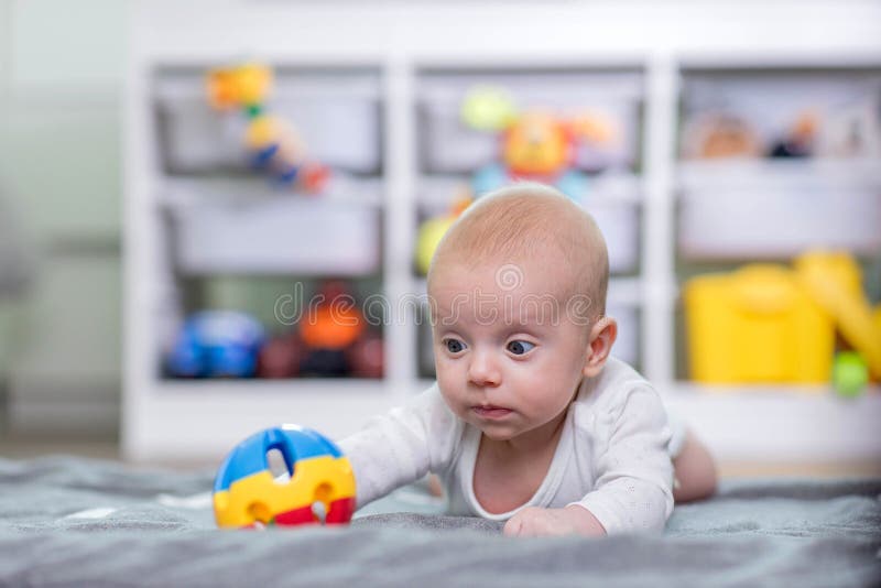 Baby Reaching for Toy. Baby Development Stock Photo - Image of baby ...