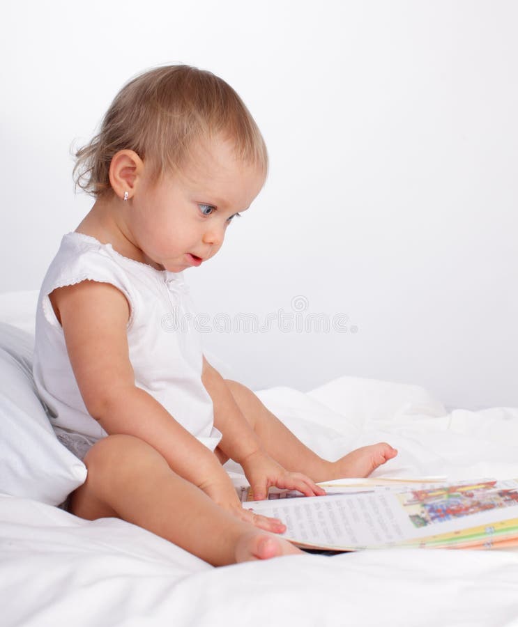 Small child reading a book stock image. Image of looking - 17985557