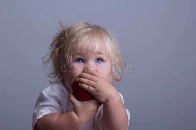Baby a red apple stock image. Image of kiddie, affectionate - 63314543
