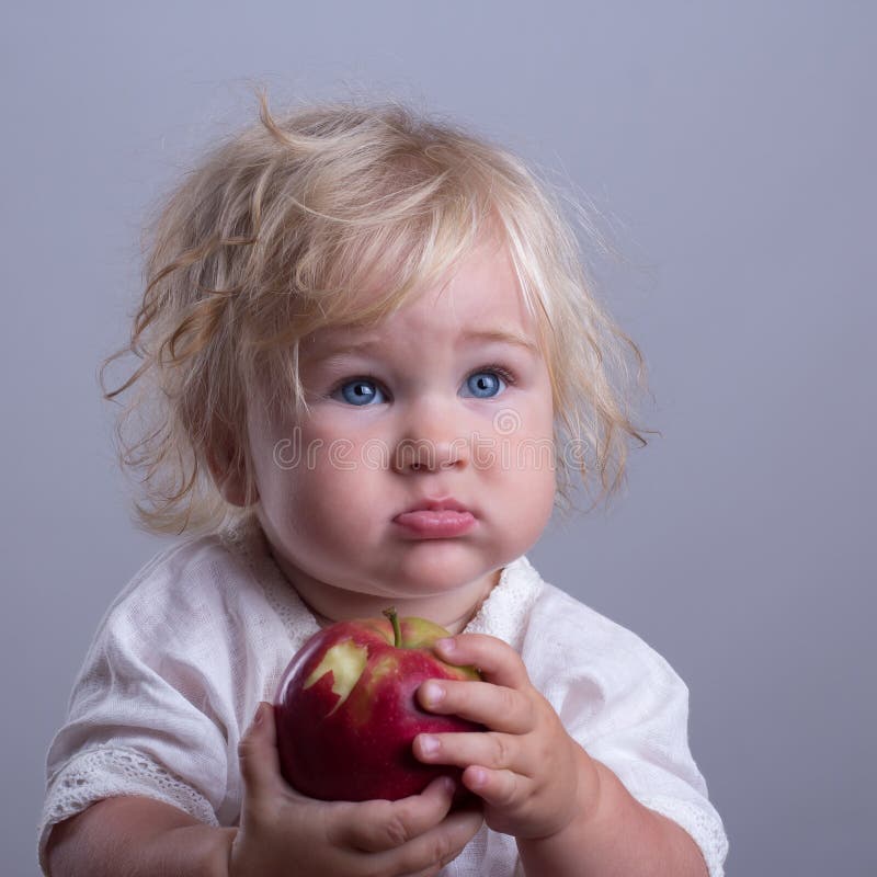 Baby a red apple stock image. Image of affectionate, blond - 63314595
