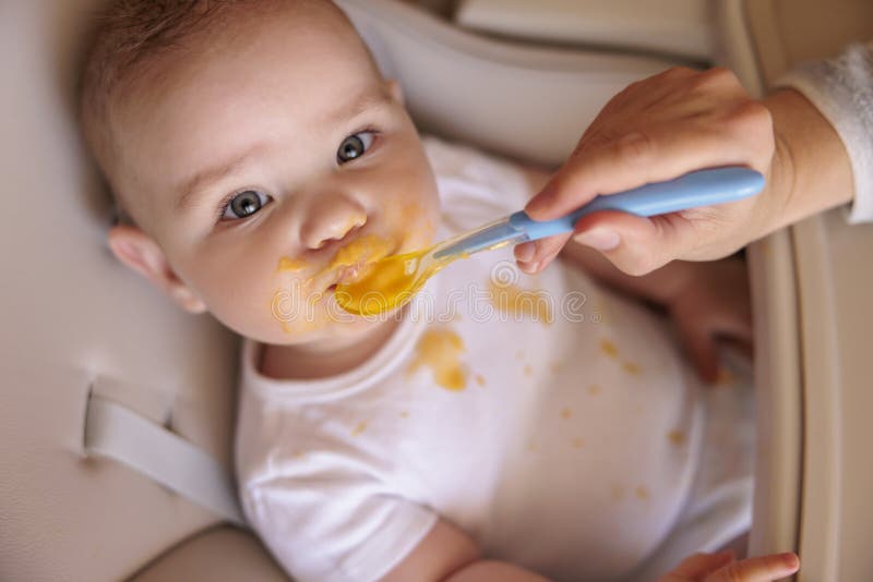 Baby Refusing Food while Mother Feeding Him Stock Image - Image of ...