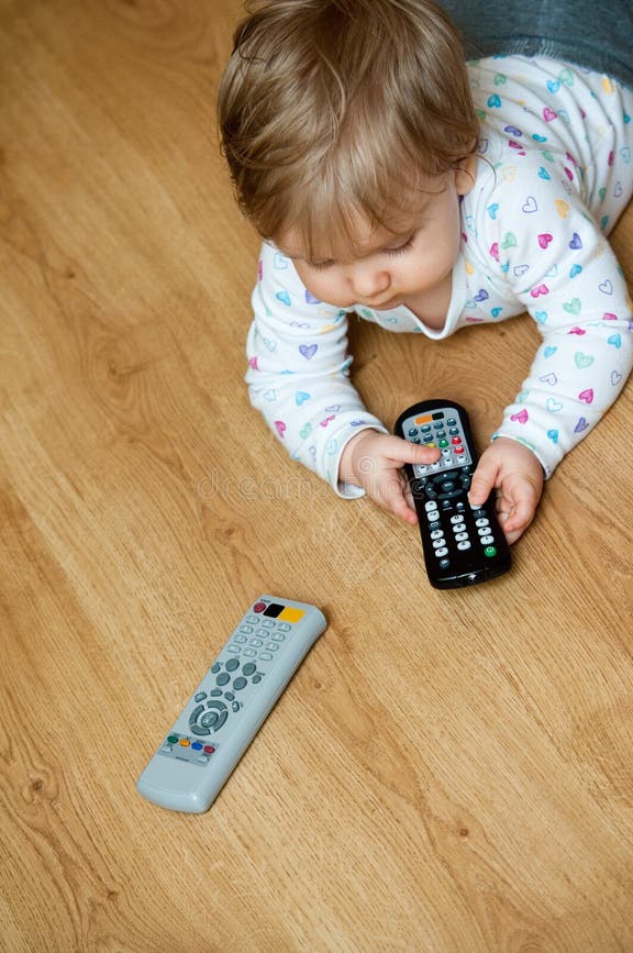 Baby with remote controls stock image. Image of crop - 18873763