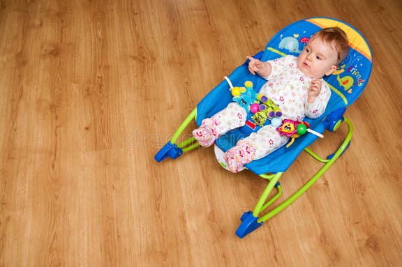 Baby in rocker stock image. Image of girl, laminate, infant - 16571601