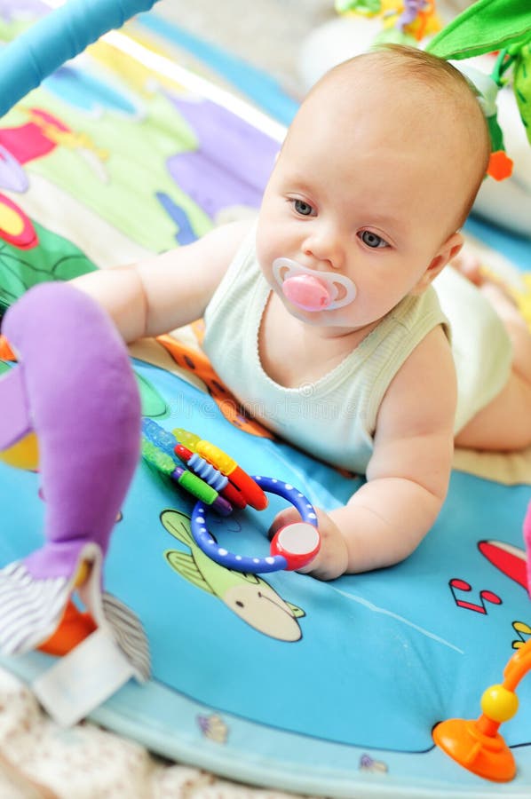 Baby on the rug stock image. Image of child, look, developing - 117476013