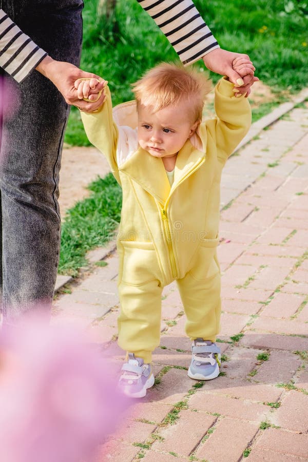 Baby& X27;s First Steps with Loving Mother& X27;s Help Stock Photo ...