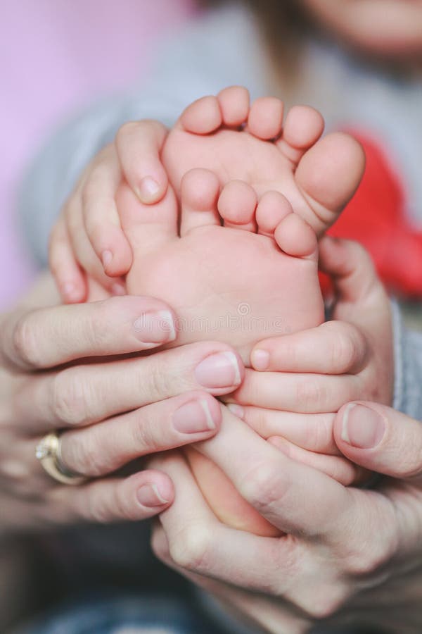 Baby`s Legs and Mom`s Hands are Interlaced Stock Image - Image of child ...