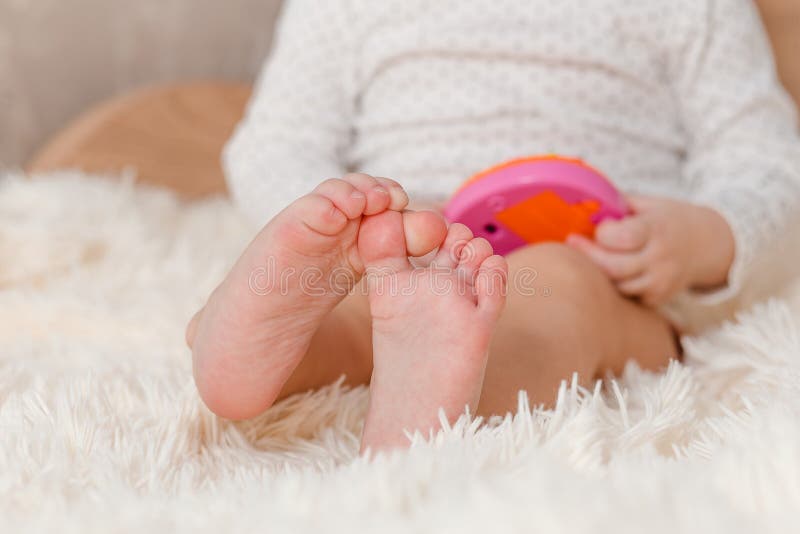 Baby`s Legs Sitting on the Bed Close Stock Photo - Image of apartment ...