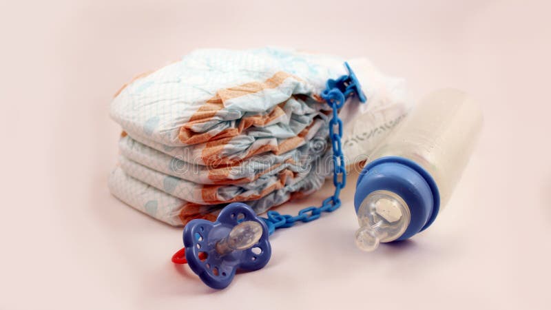 Baby S Pacifier and Stack of Diapers Stock Photo - Image of disposable ...