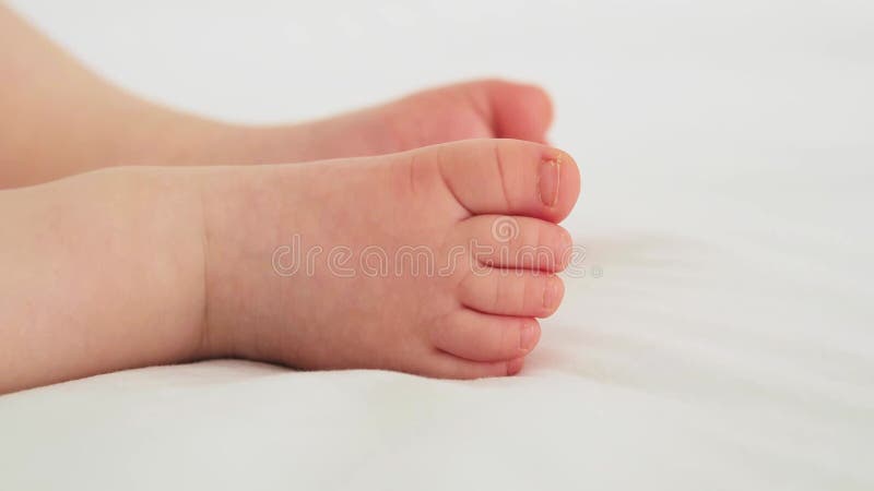 A Baby S Small Foot on a White Background of the Bed, a Newborn Baby S ...