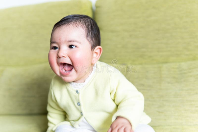 Baby Screaming at the Top of His Lungs, Sitting on the Sofa at Home ...