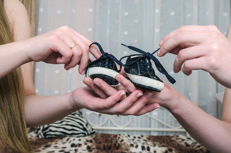 Baby Shoes on Parental Hand Stock Image - Image of cute, nanny: 51687671