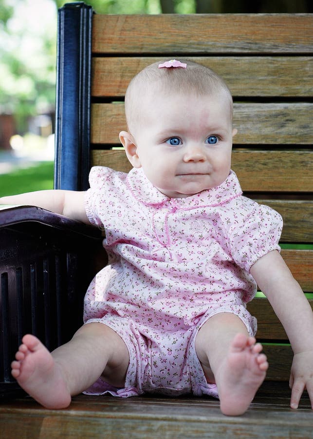 Baby Sitting on Bench - Vertical Stock Image - Image of grass, park ...