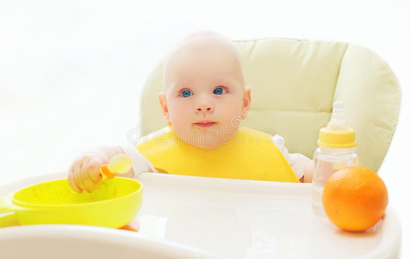 Baby Sitting at Table Home and Eats Spoon Stock Photo - Image of care ...