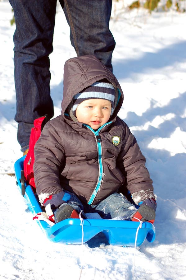 Baby on sledge stock photo. Image of snow, sledge, slide - 23384870