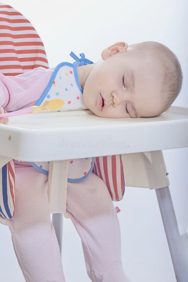 Baby Sleeping while Eating in a Chair Stock Photo - Image of lying ...