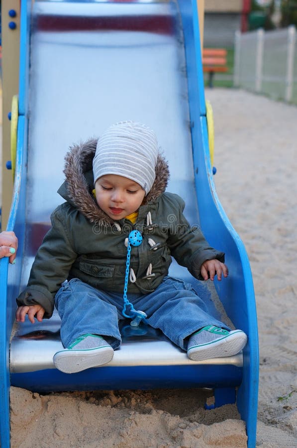 Baby on slide stock image. Image of play, sand, sitting - 54312537