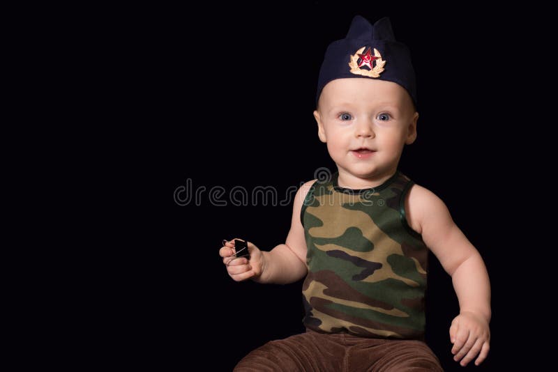 A Child Soldier in Uniform with War Paint on His Face. Boy in Uniform ...