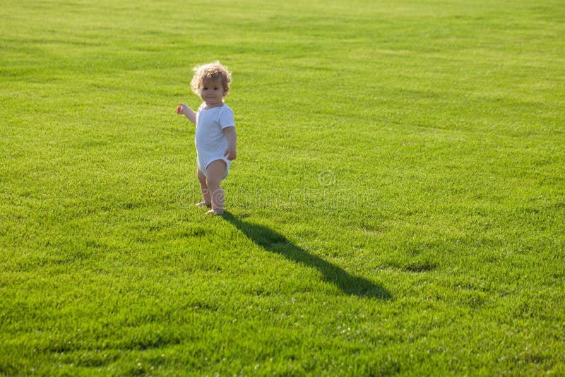 Baby Standing Barefoot on the Green Lawn. Stock Photo - Image of spring ...