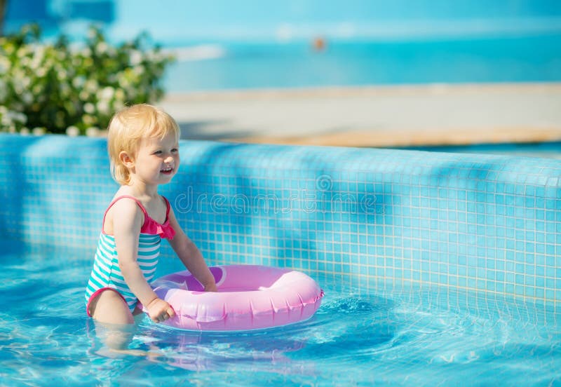 Baby Standing in Pool with Inflatable Ring Stock Photo - Image of ...