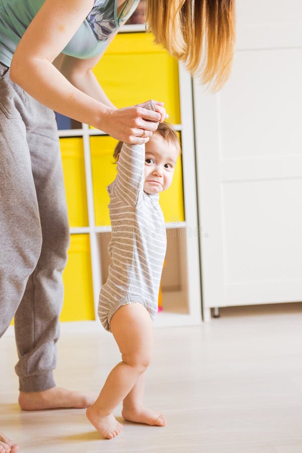 Baby Steps with the Help of His Mother Stock Image - Image of parenting ...