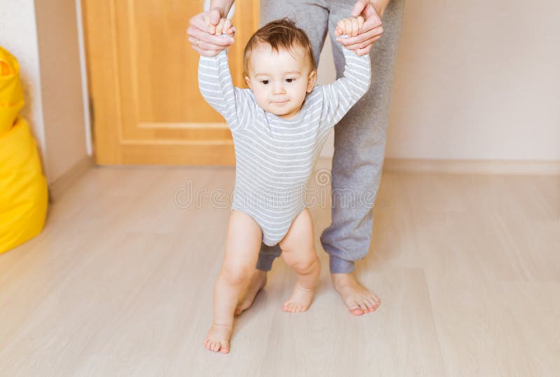 Baby Steps with the Help of His Mother Stock Photo - Image of help ...