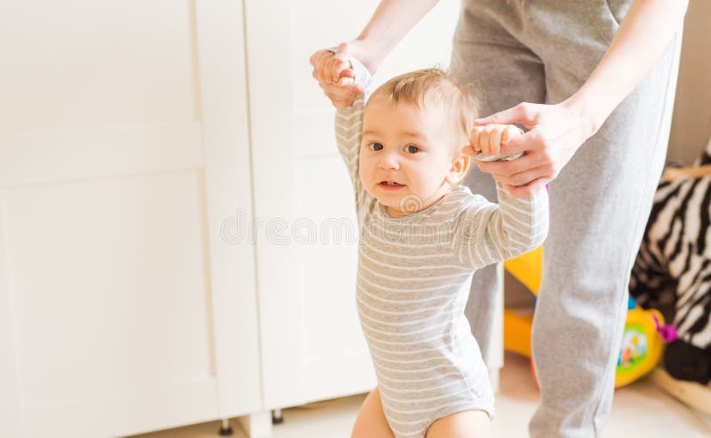 Baby Steps with the Help of His Mother Stock Image - Image of people ...