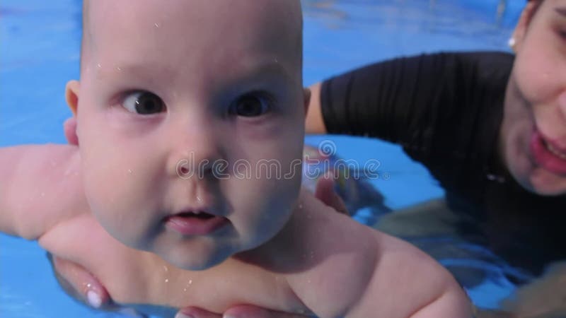 Baby Swimming with Instructor in Indoor Pool Stock Video - Video of ...