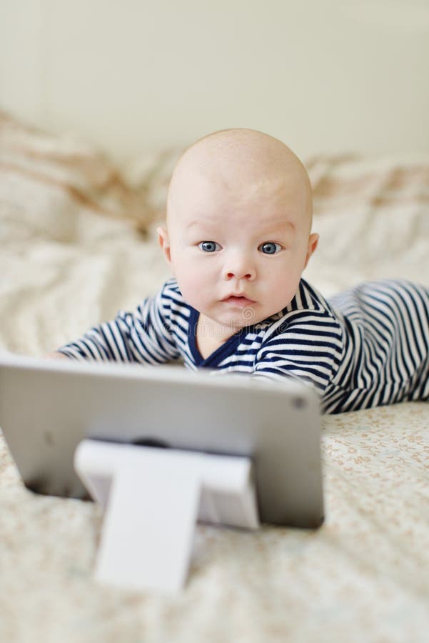 Baby with tablet pc stock image. Image of attention - 177716025