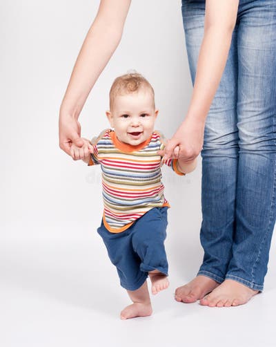 Baby taking first steps stock image. Image of hold, parent - 21287979